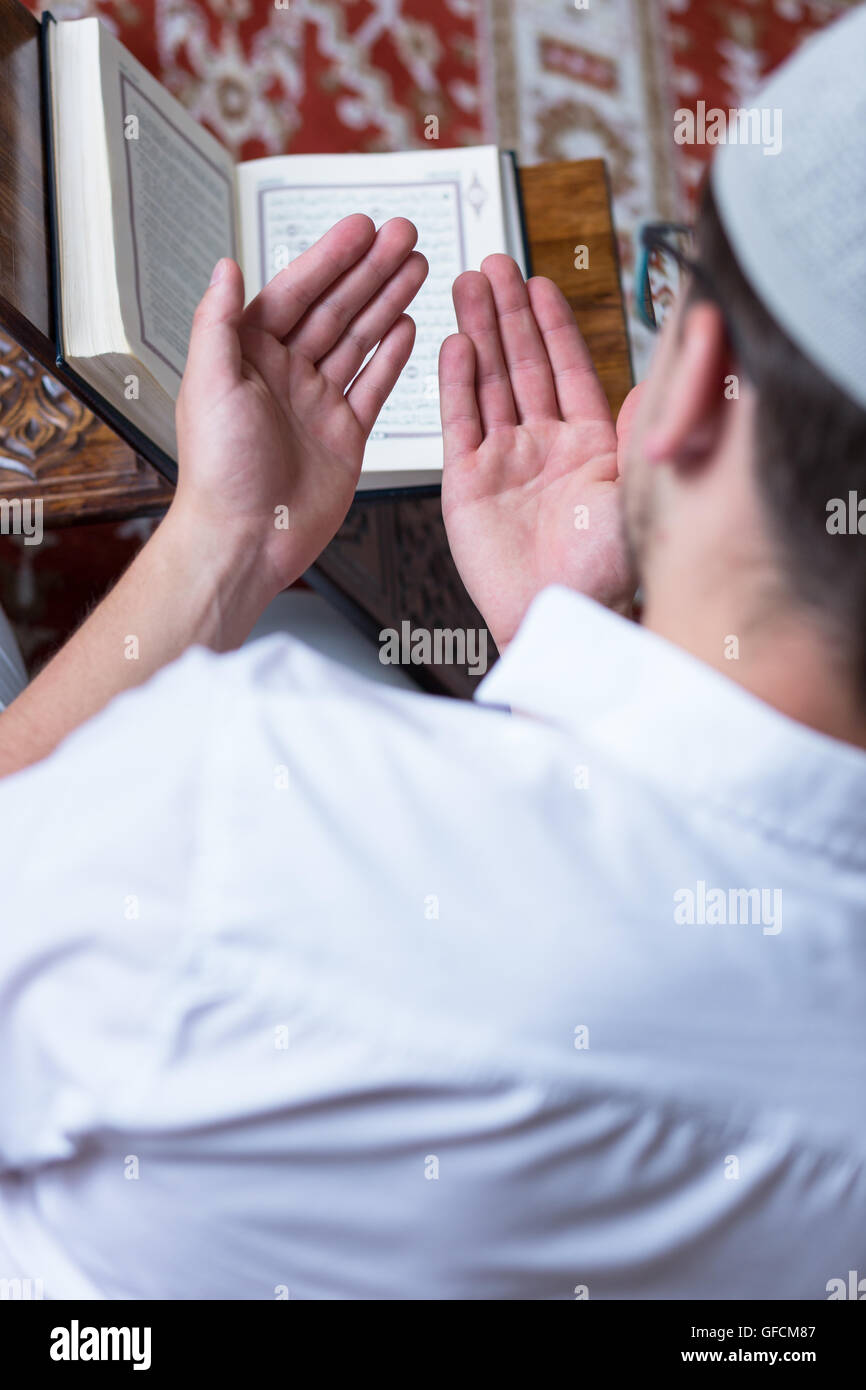 a muslim man is reading quran Stock Photo - Alamy