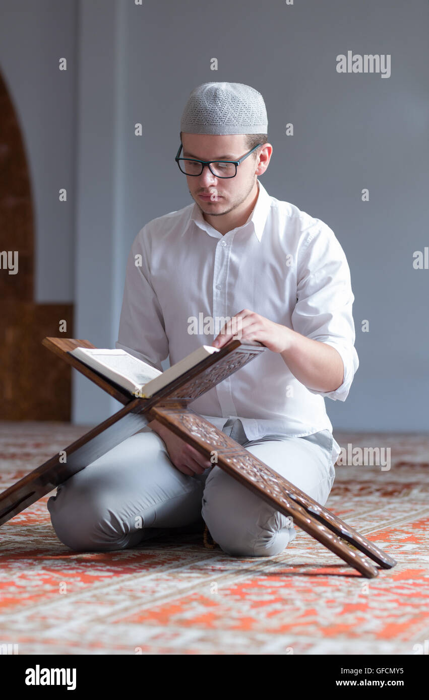a muslim man is reading quran Stock Photo - Alamy