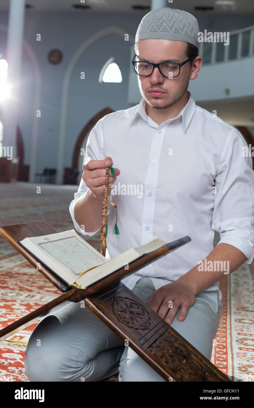 a muslim man is reading quran Stock Photo - Alamy