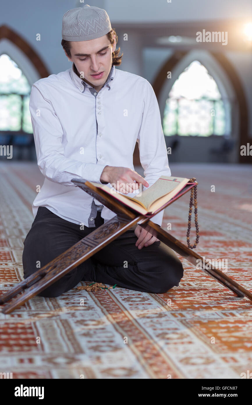 a muslim man is reading quran Stock Photo - Alamy