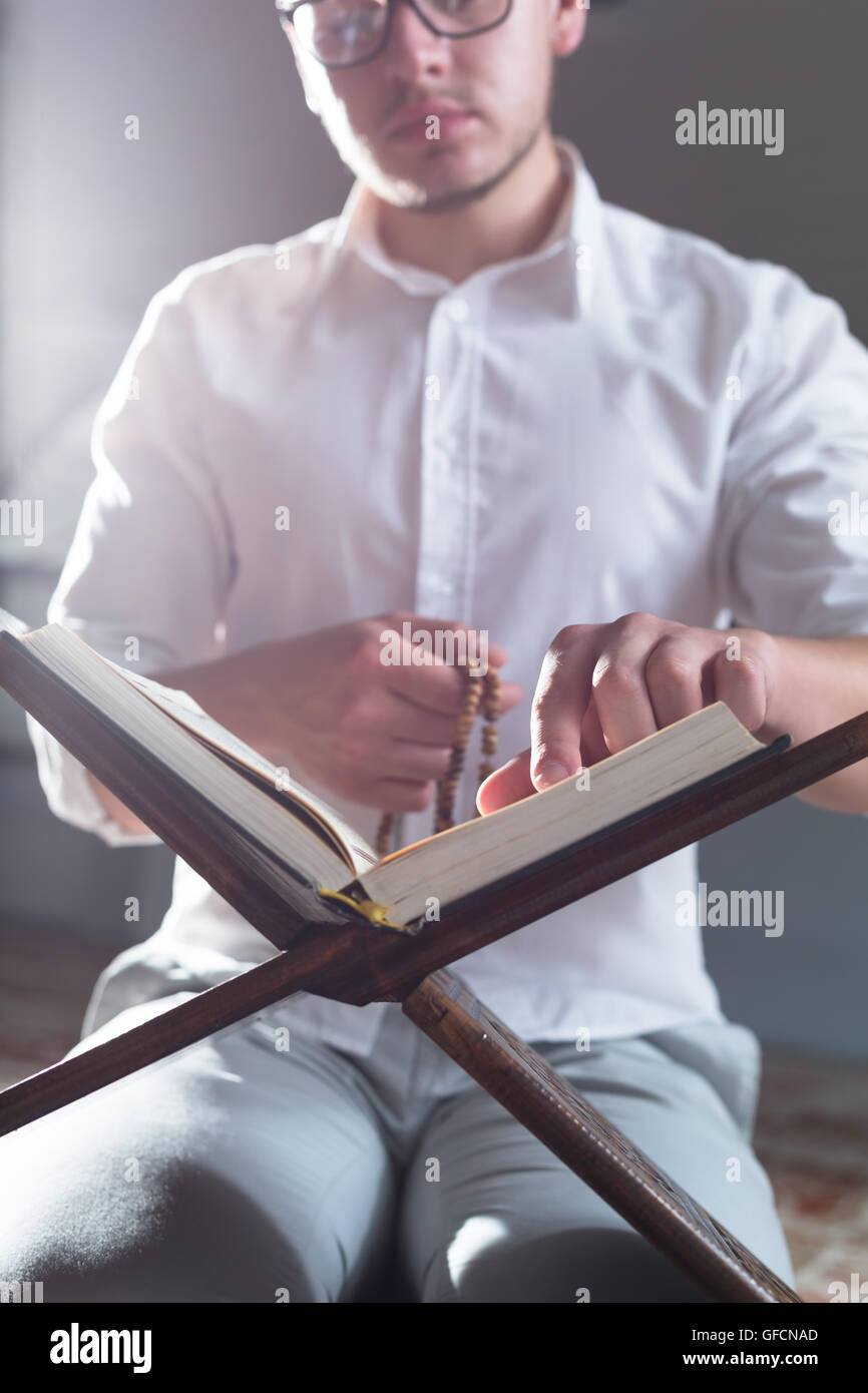 a muslim man is reading quran Stock Photo - Alamy