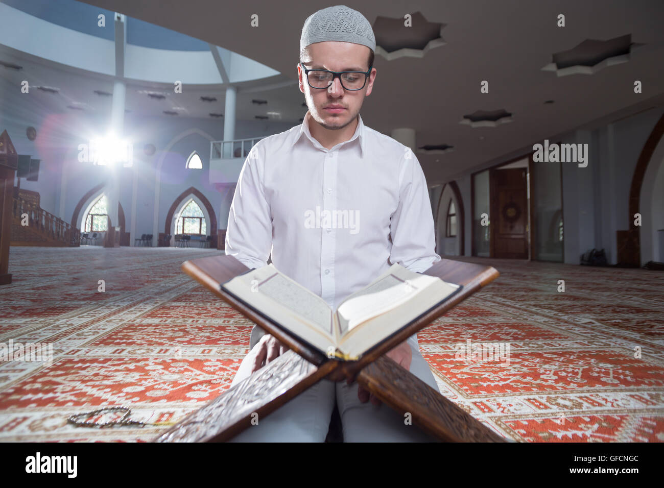 a muslim man is reading quran Stock Photo - Alamy