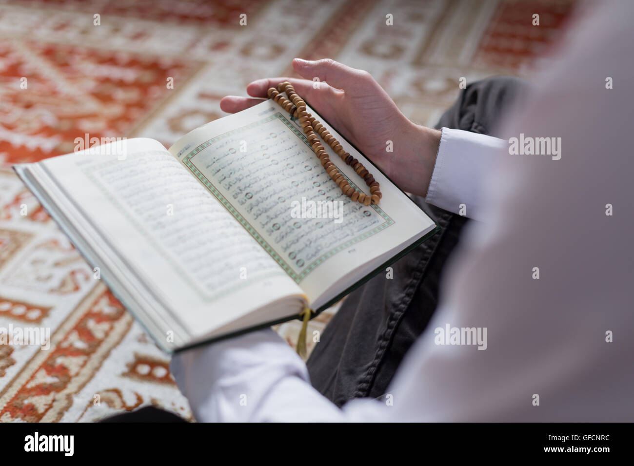 Koran in hand - holy book of Muslims ( public item of all muslims Stock ...