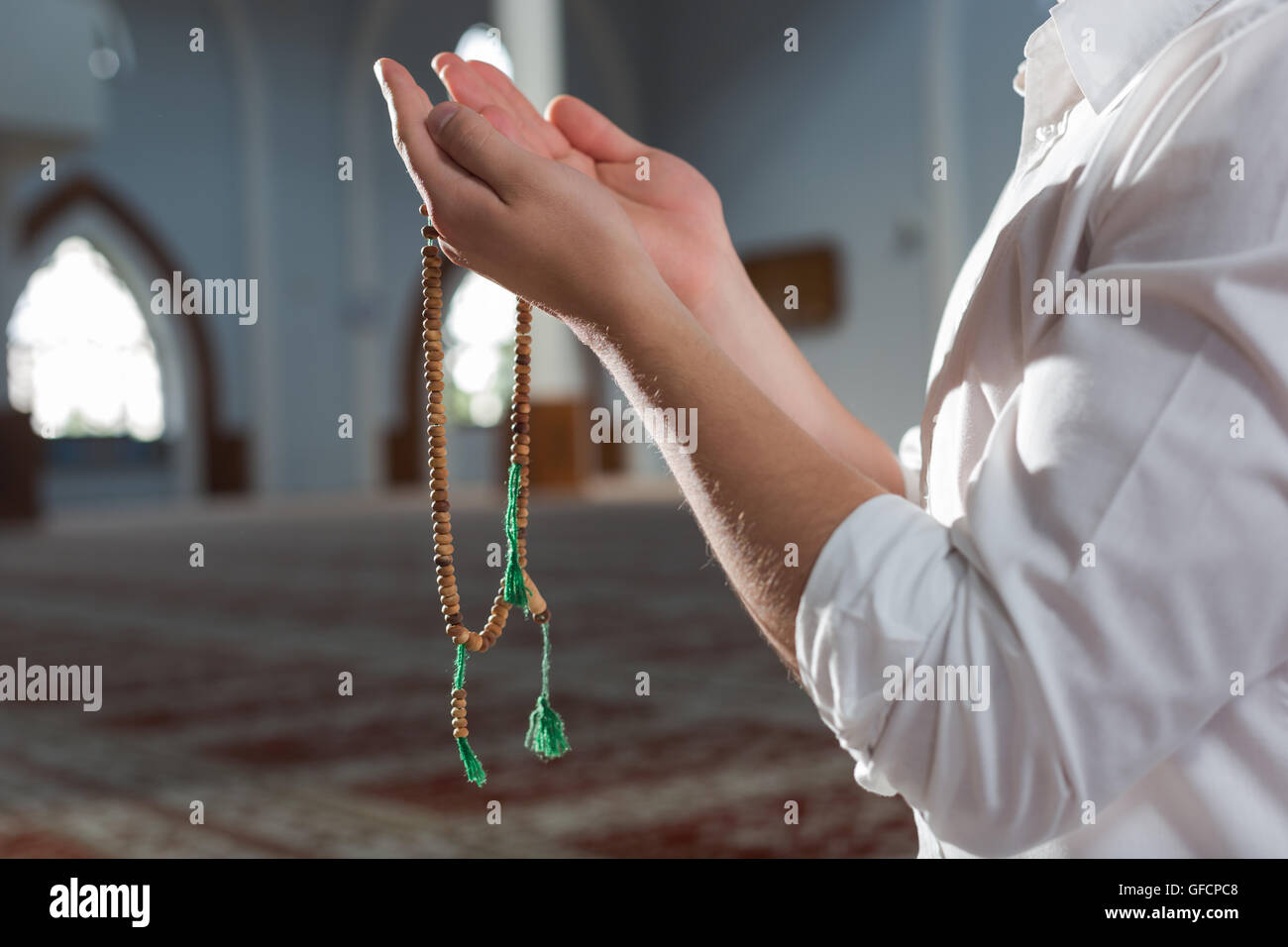 hand holding a muslim rosary Stock Photo - Alamy