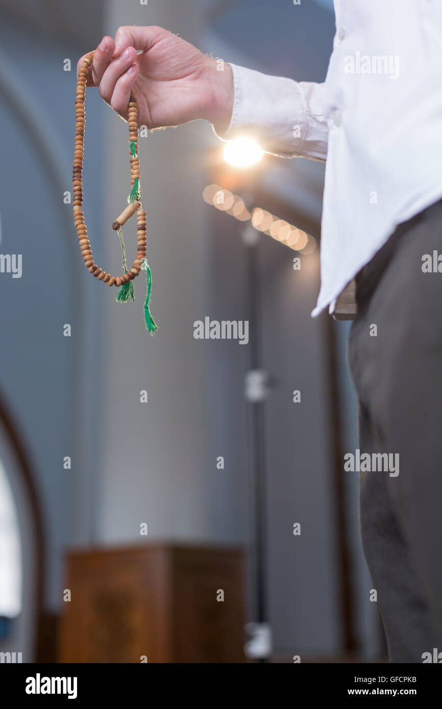 hand holding a muslim rosary Stock Photo - Alamy