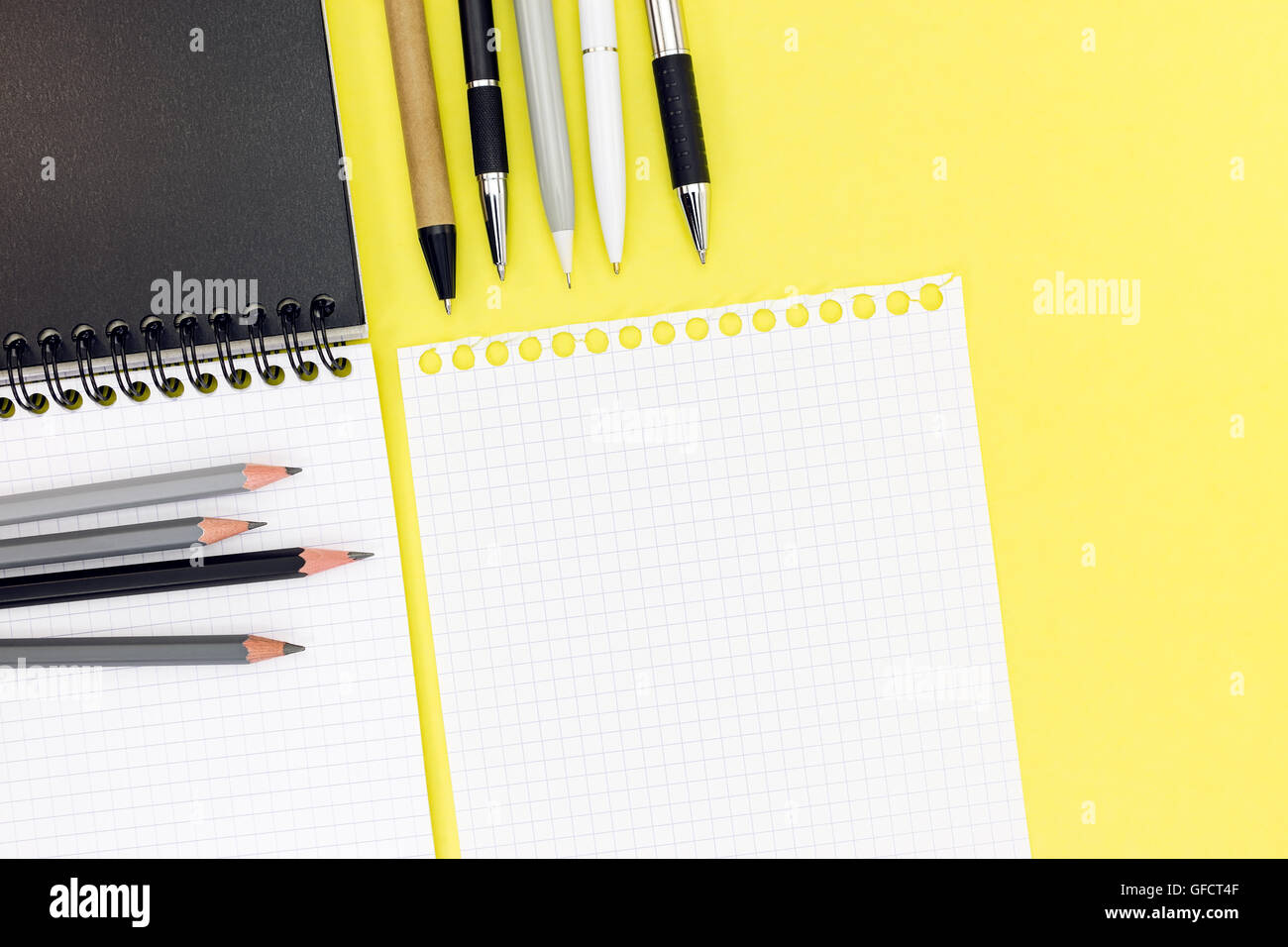 blank notepad, piece of white paper, ballpoint pens and graphite ...