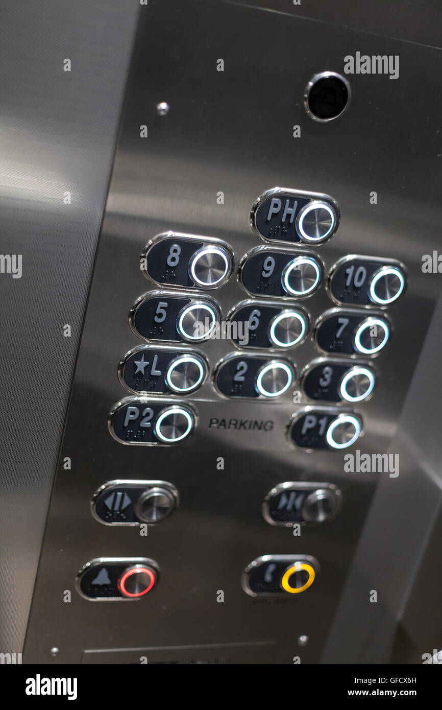 Full frame of numbered buttons with braille markings on elevator ...