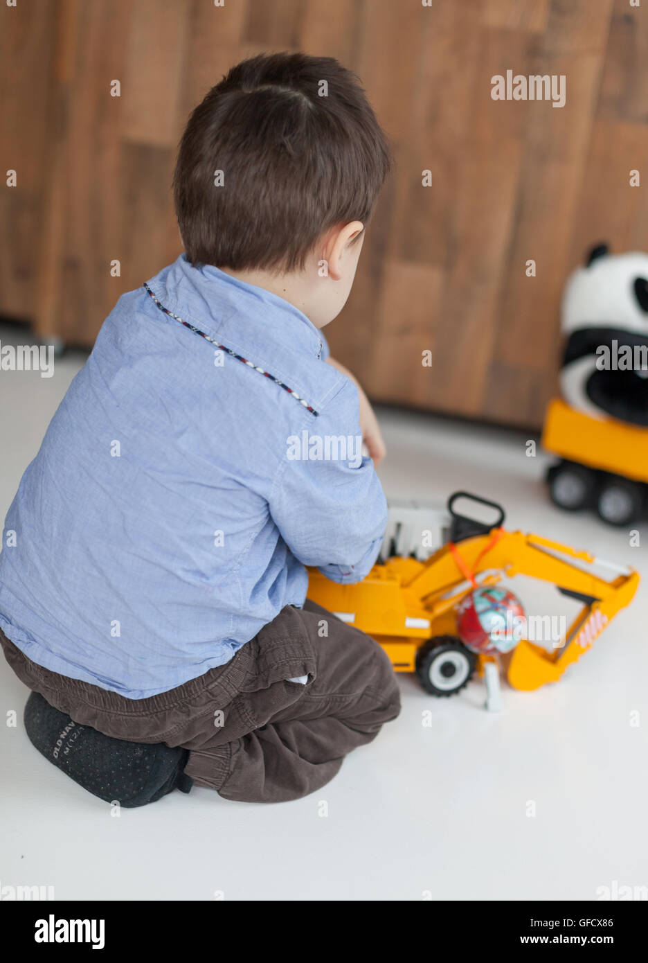 Rear view of a little boy playing with toy at homecolor image, canon ...