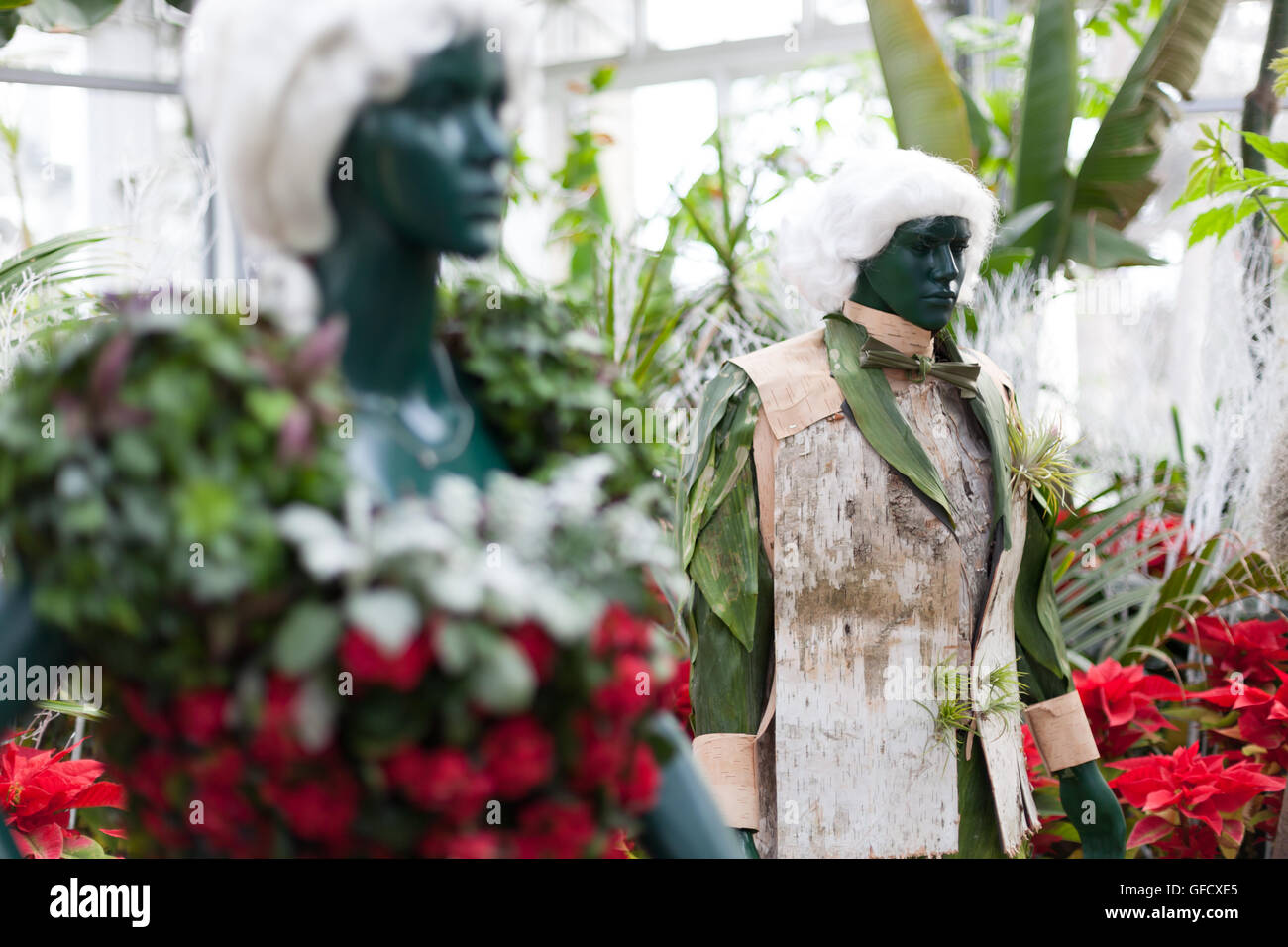 Statues wearing clothes made of colorful Christmas flowers displayed at ...