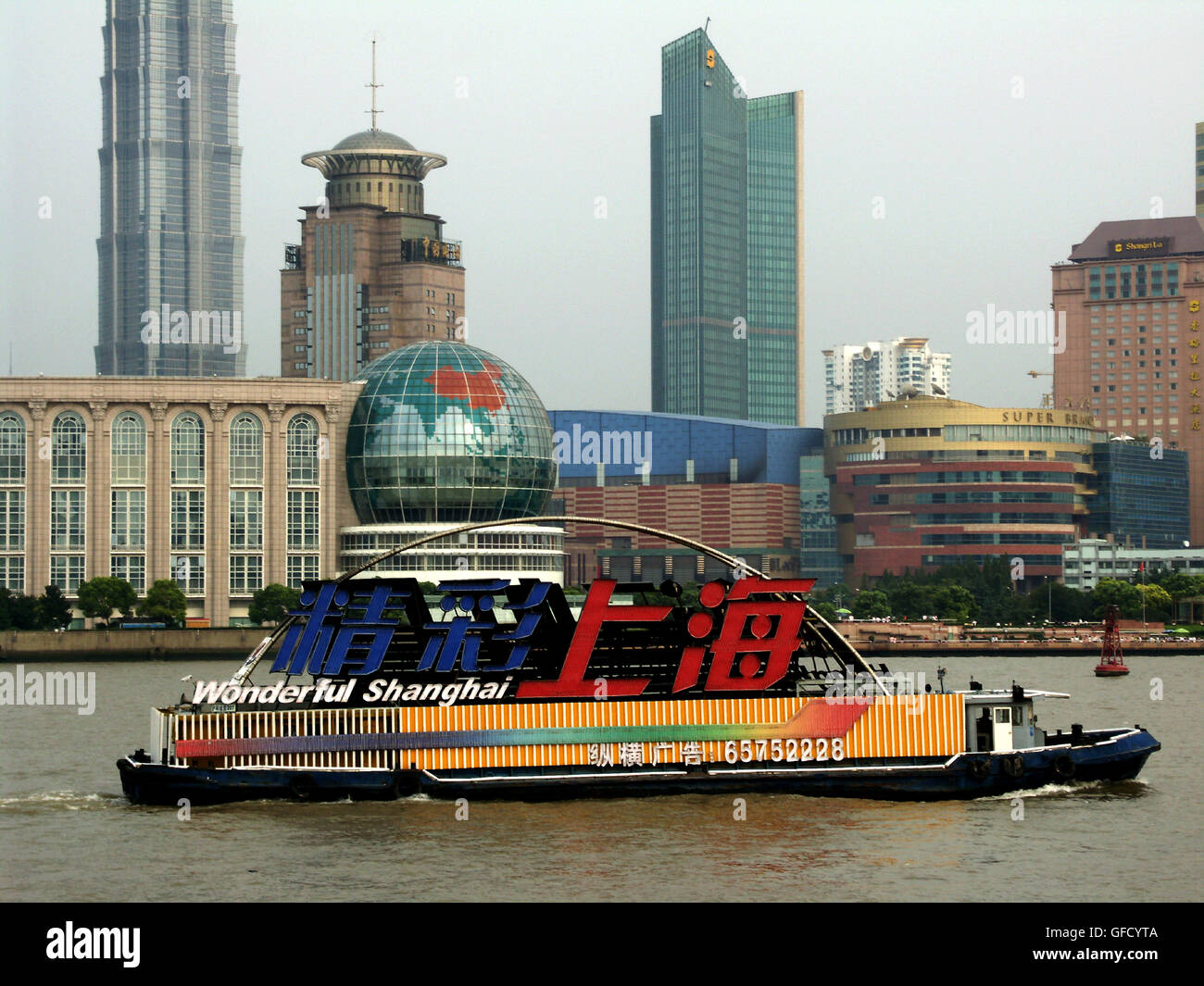 The “Wonderful Shanghai” cruise boat against the skyline of Shanghai’s ...