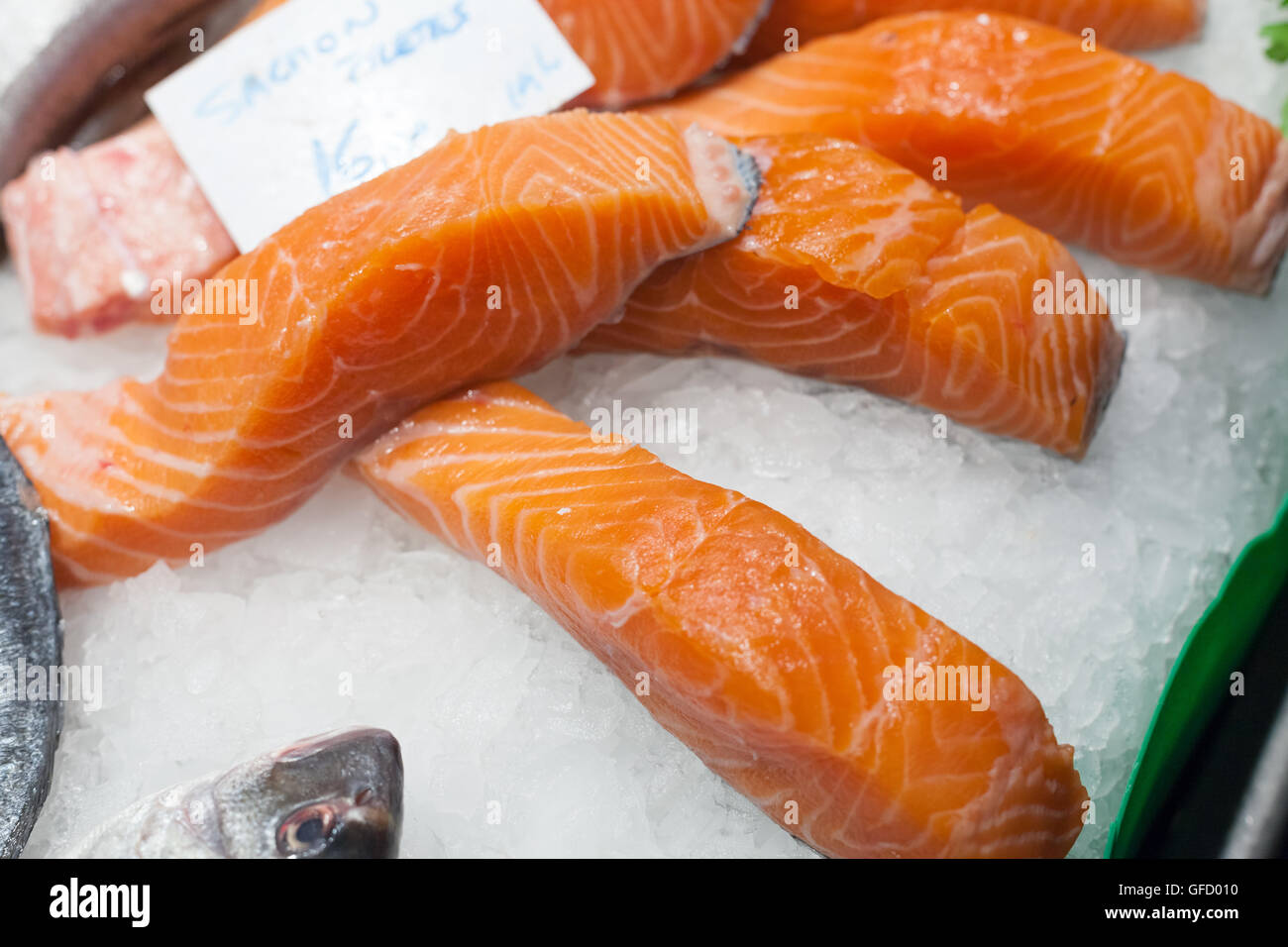 Display of frozen salmon slices for sale at a market stall, La Boqueria ...