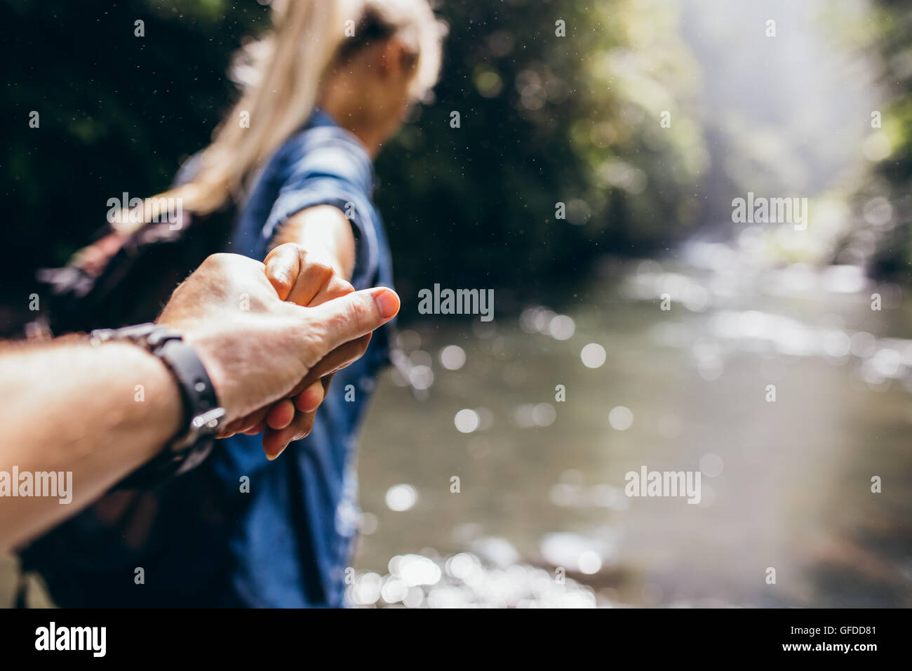 Two hikers in nature. Closeup of man and woman holding hands while ...