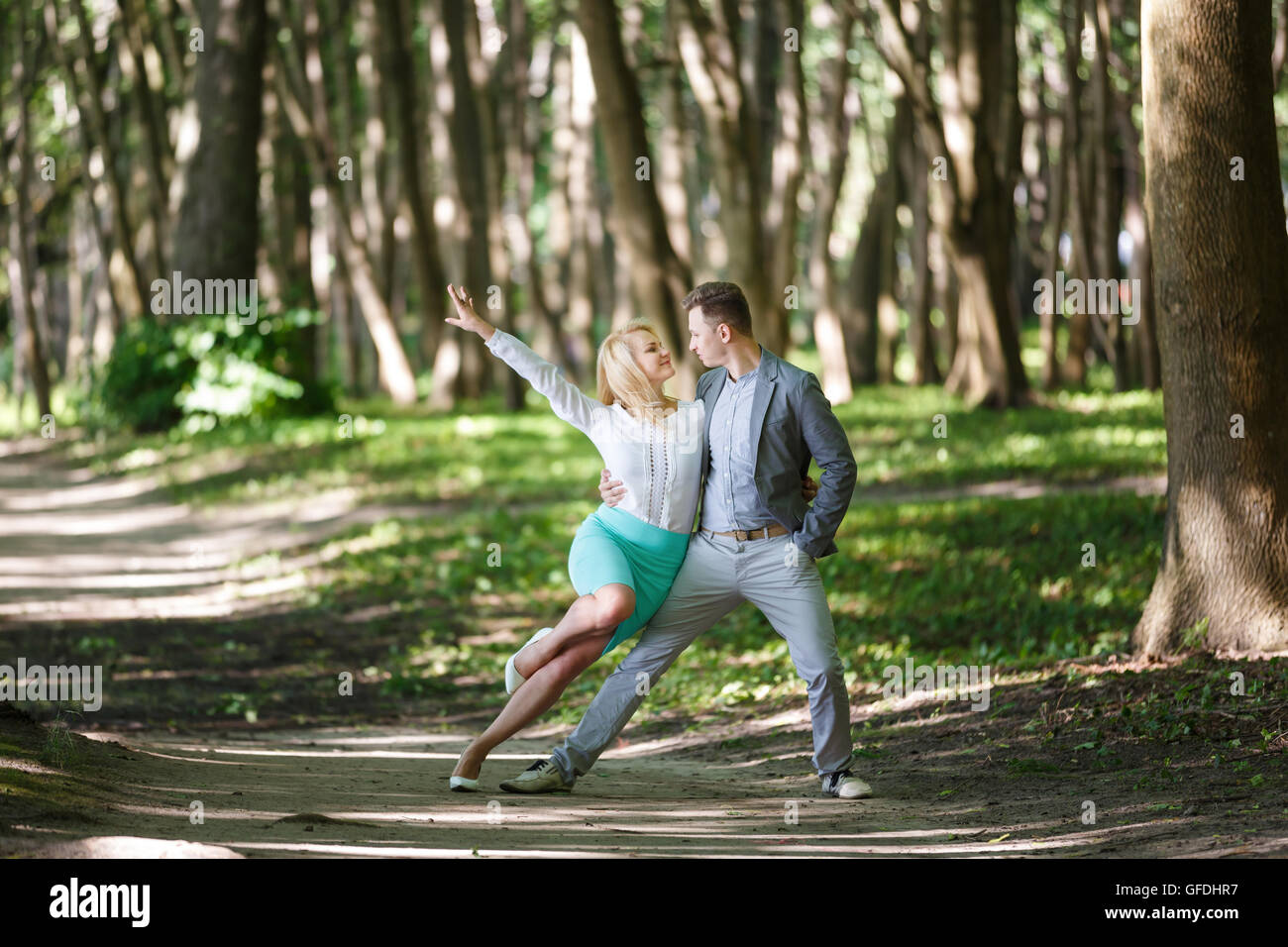 Cheerful couple are dancing in the forest, summer time Stock Photo - Alamy