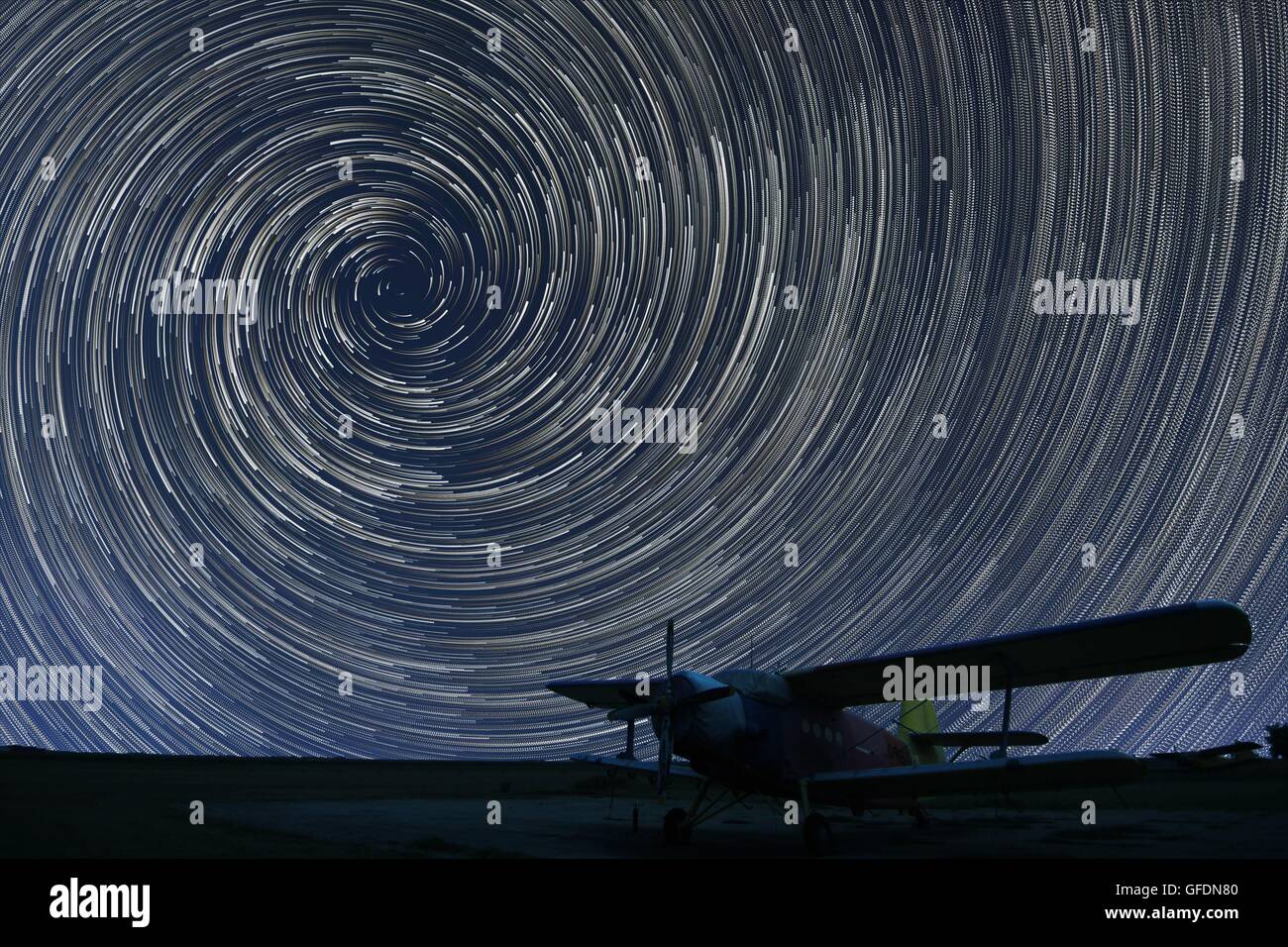 Beautiful night sky, Spiral Star trails over small airport lonely ...