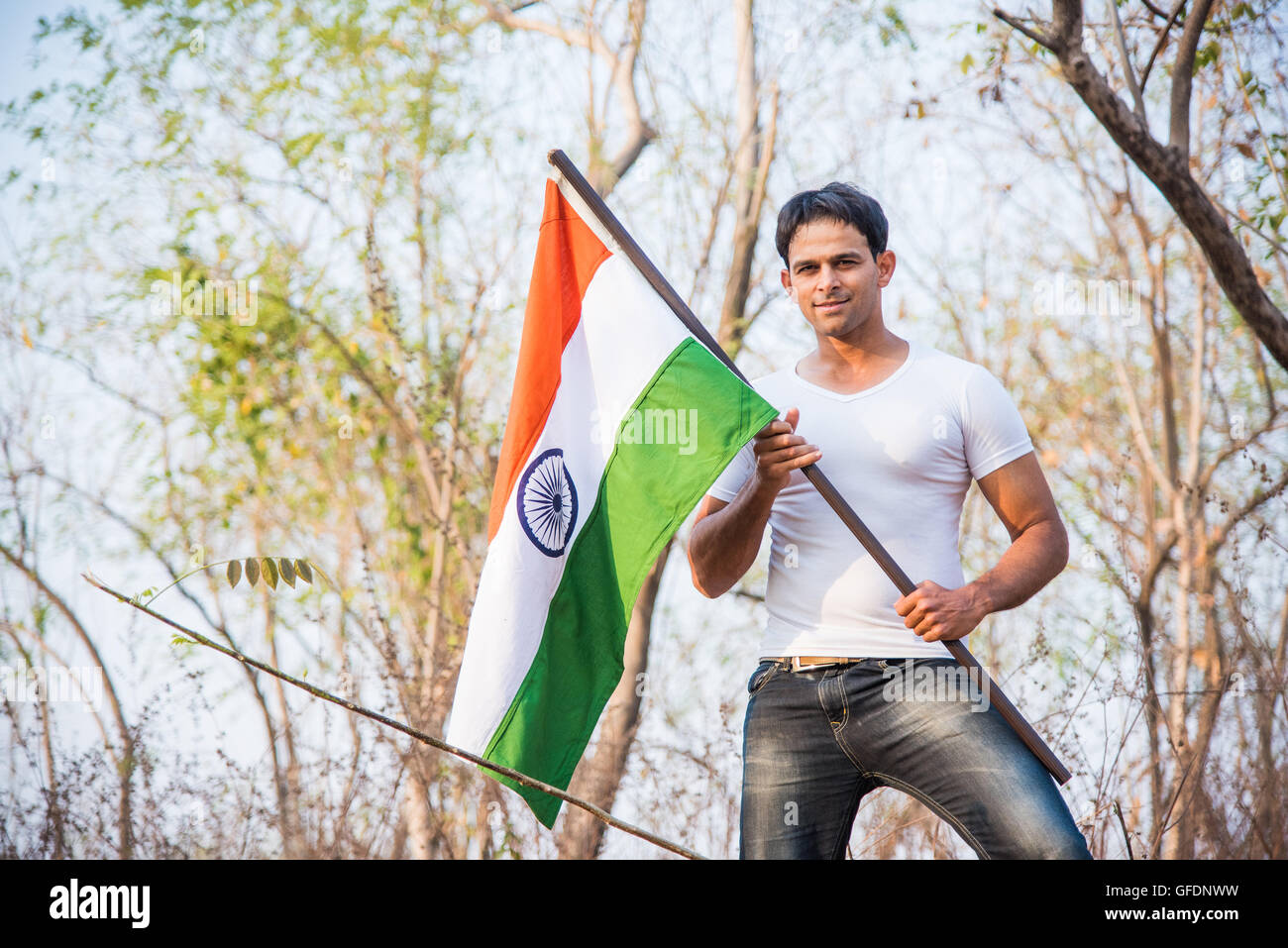 indian young man holding and waving indian flag, conceptual image for ...