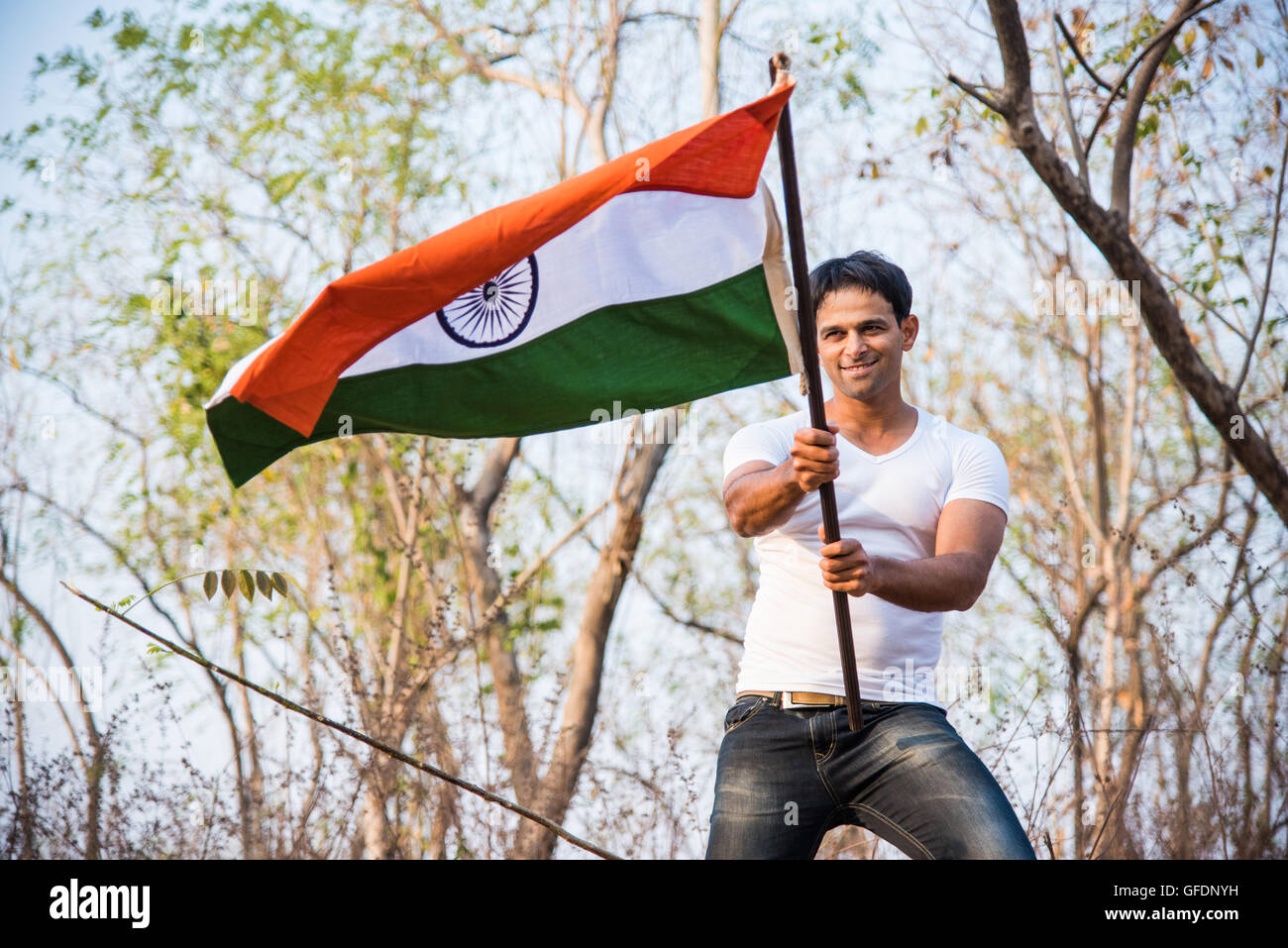indian young man holding and waving indian flag, conceptual image for ...