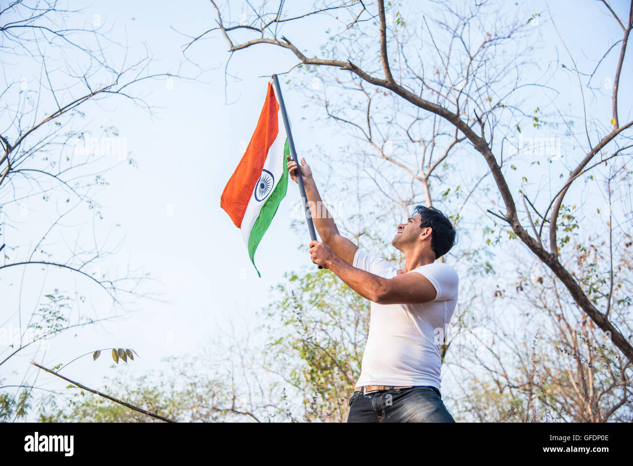 indian young man holding and waving indian flag, conceptual image for ...
