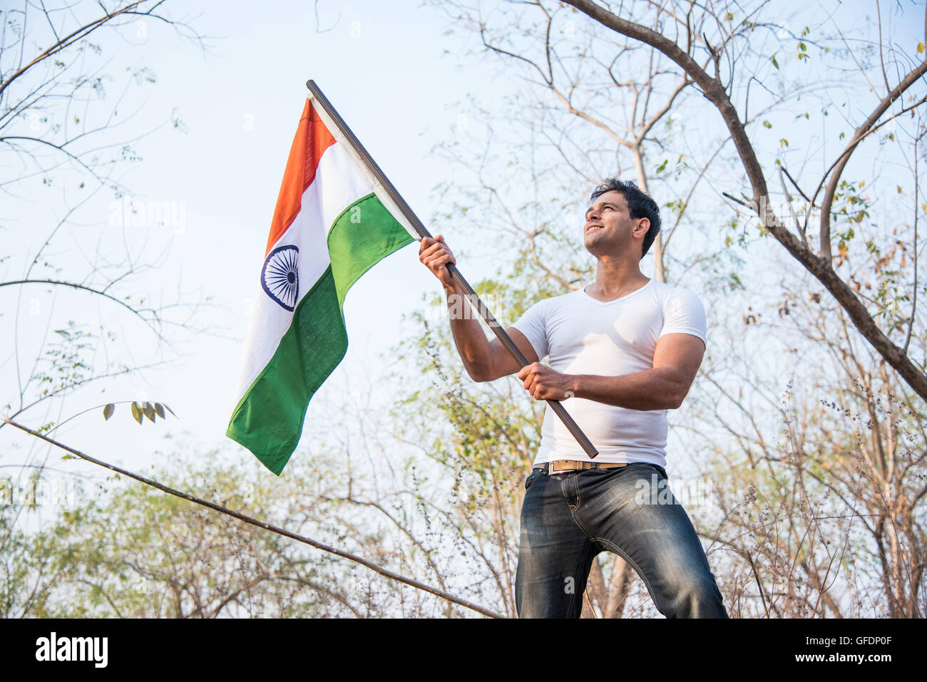 indian young man holding and waving indian flag, conceptual image for ...