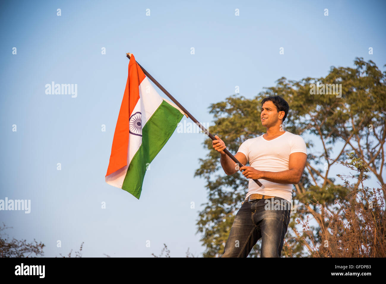 indian young man holding and waving indian flag, conceptual image for ...