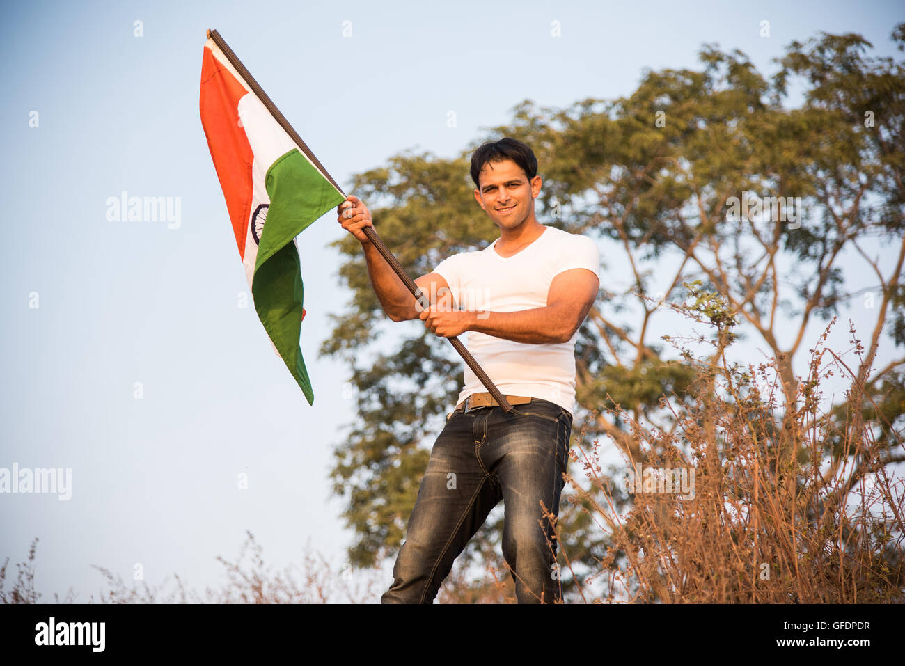 indian young man holding and waving indian flag, conceptual image for ...