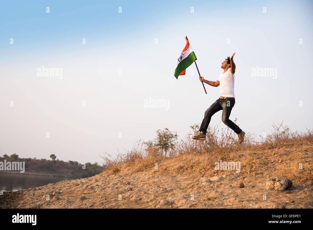 indian young man holding and waving indian flag, conceptual image for ...