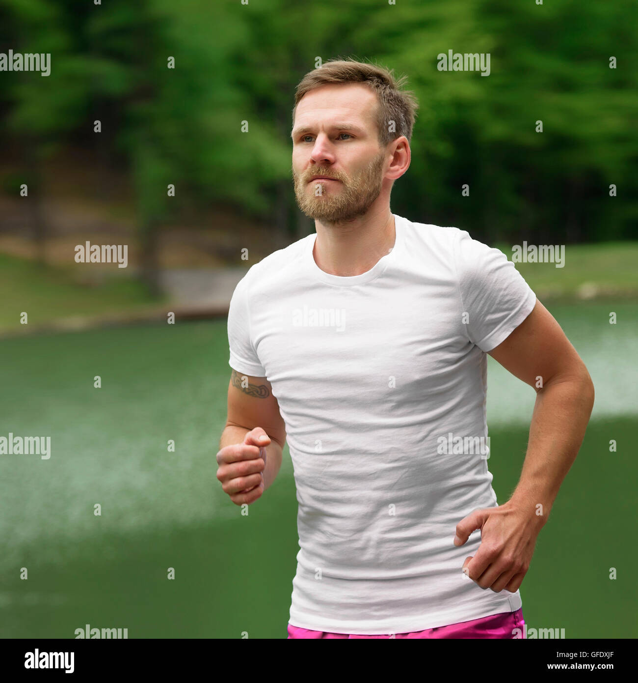 Running fitness man close-up sprinting outdoors in beautiful park Stock ...