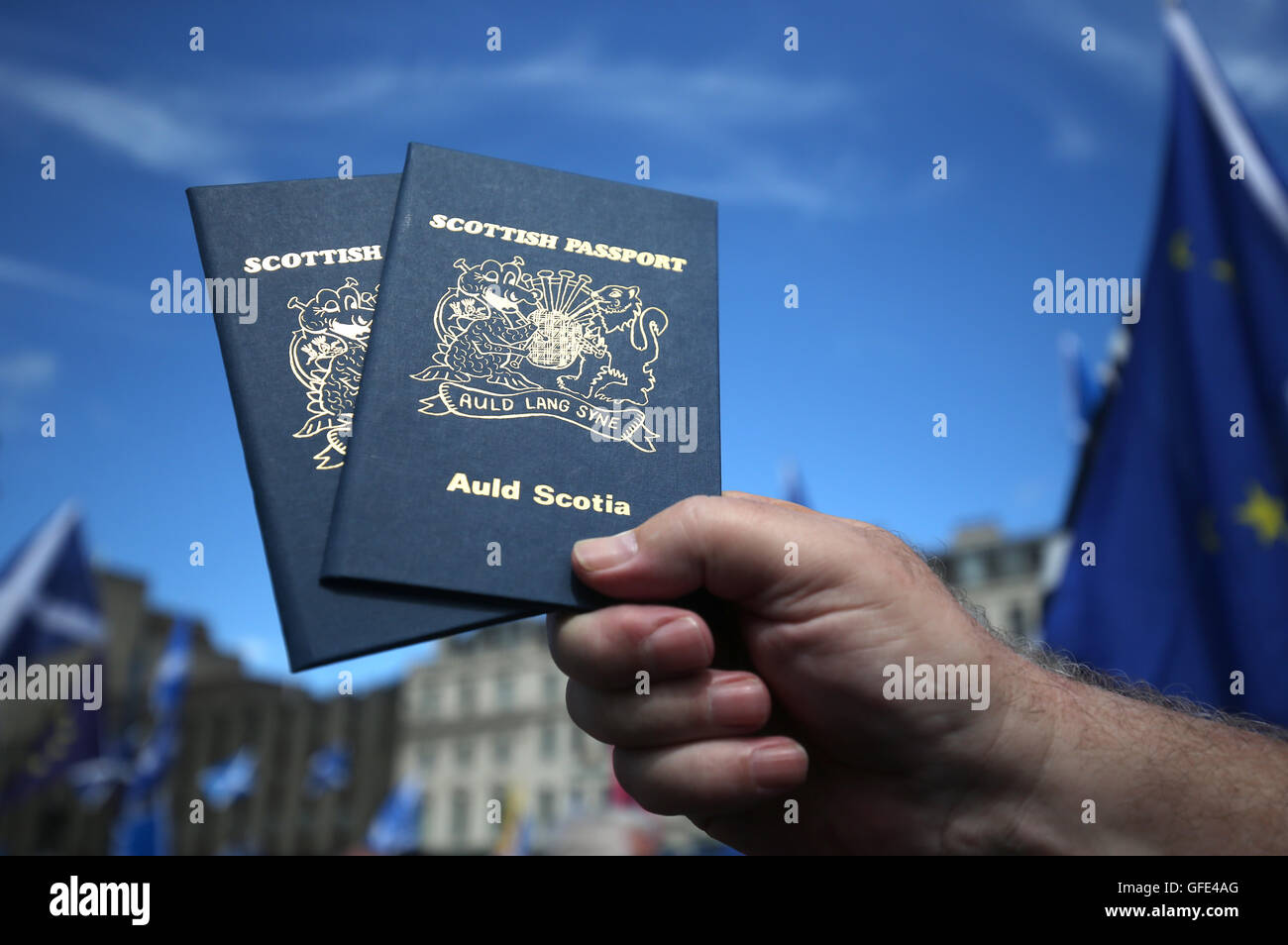A person holds Scottish passports as thousands of people take part in ...