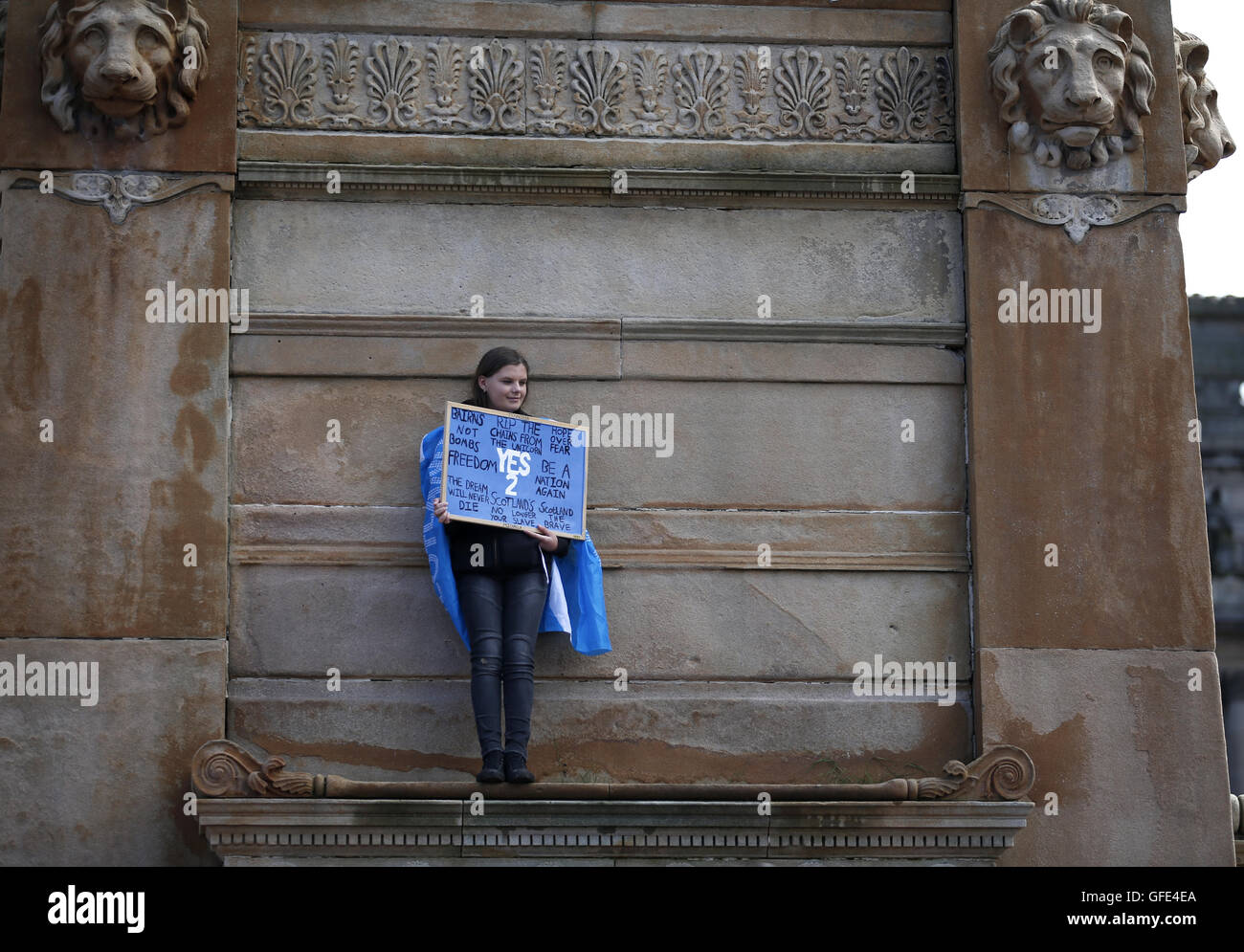 A woman holds a sign as she takes part in the 'All Under One Banner ...