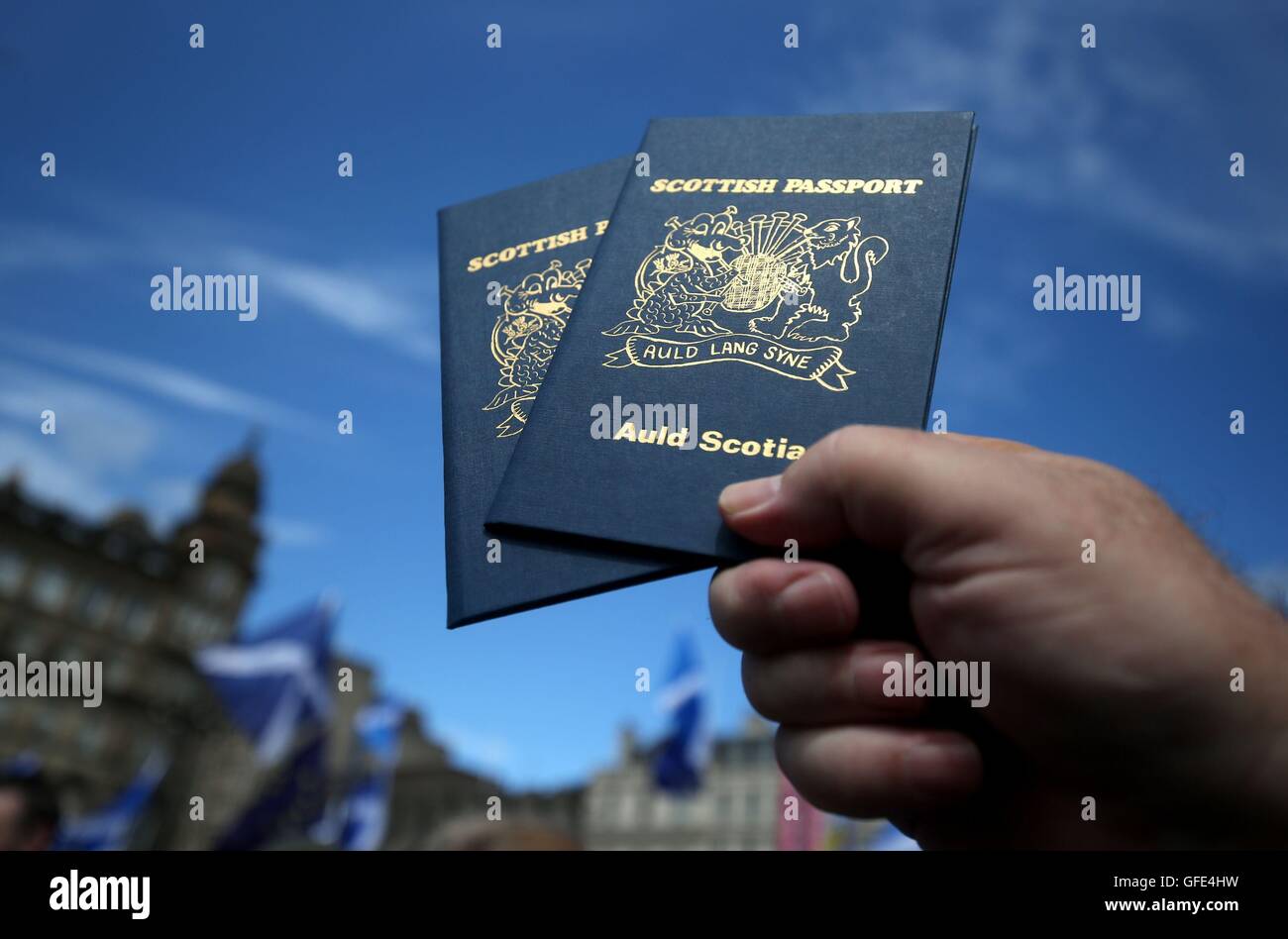 A person holds Scottish passports as thousands of people take part in ...