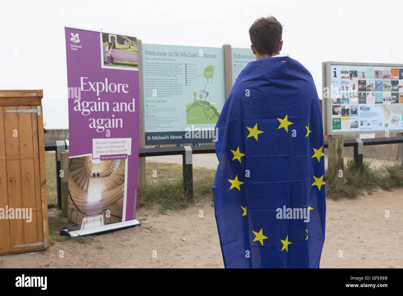 Person with eu flag in front of a rollup with slogan "explore again and ...