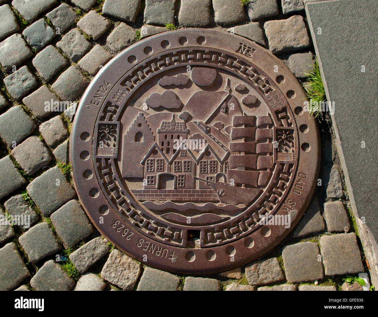 Bergen, Norway. An ornate manhole cover in the Bryggen district of ...