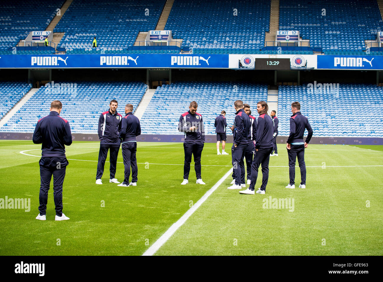 Burnley players take a walk across the pitch before the pre-season ...