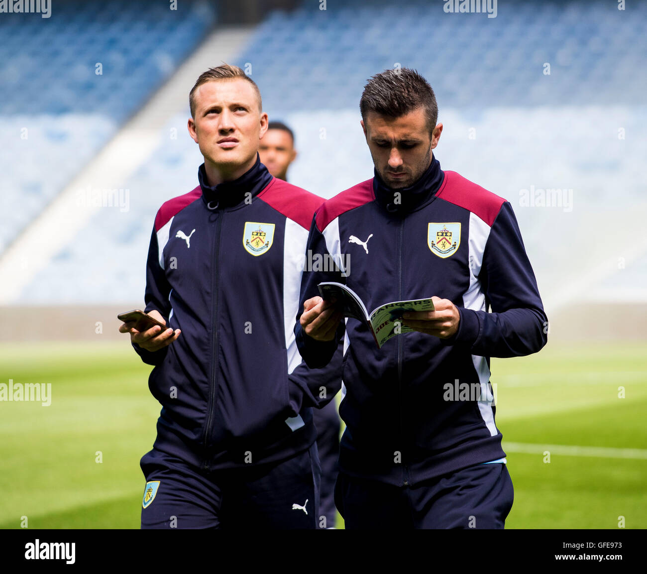 Burnley players read the matchday programme before the pre-season ...