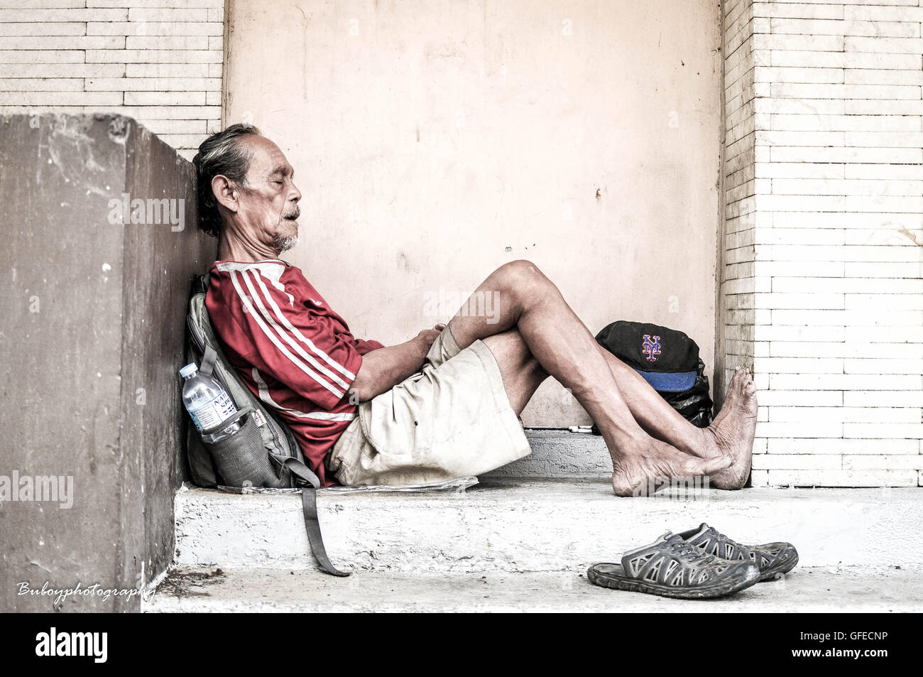 old man taking a rest on the sidewalk Stock Photo - Alamy