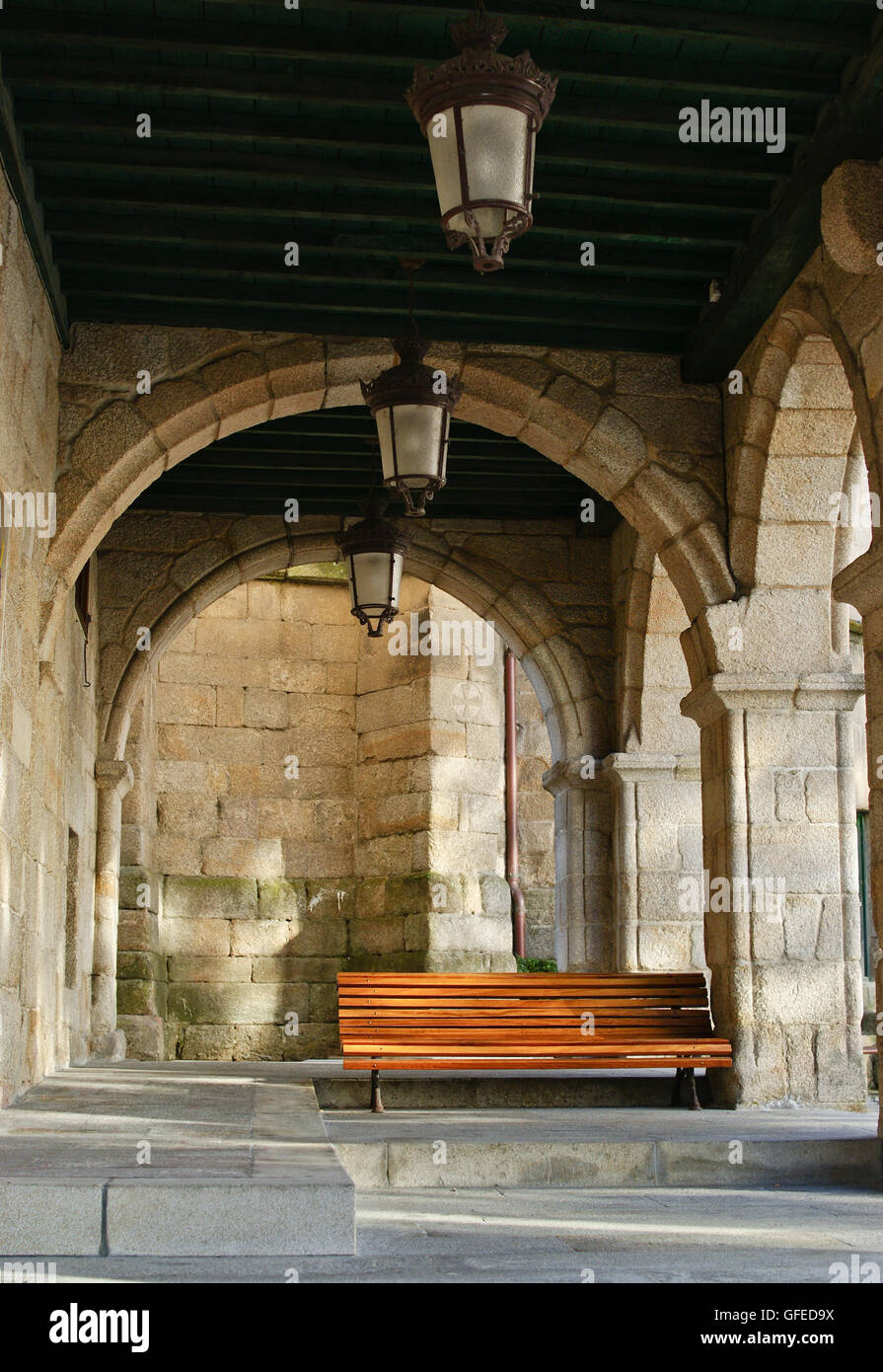 wooden bench in stone archway in Betanzos Stock Photo - Alamy