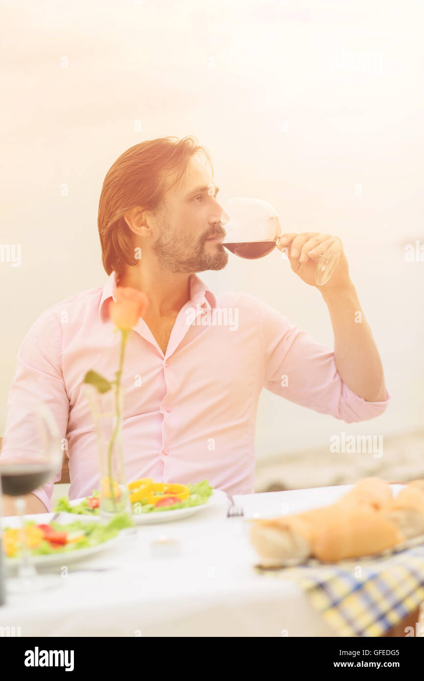 Handsome man drinking wine Stock Photo - Alamy