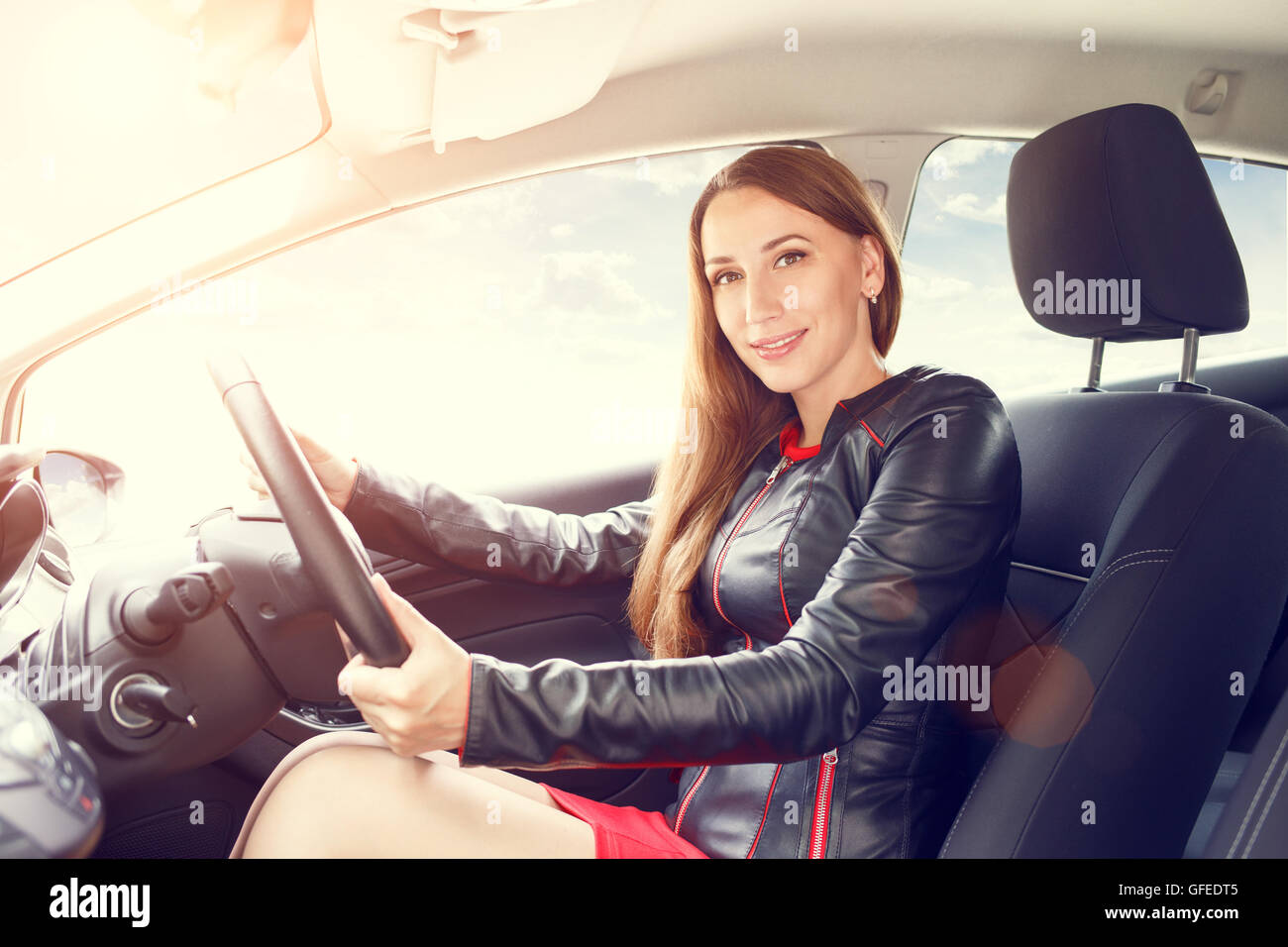 Young beautiful woman steering wheel driving a car. Confident smiling ...