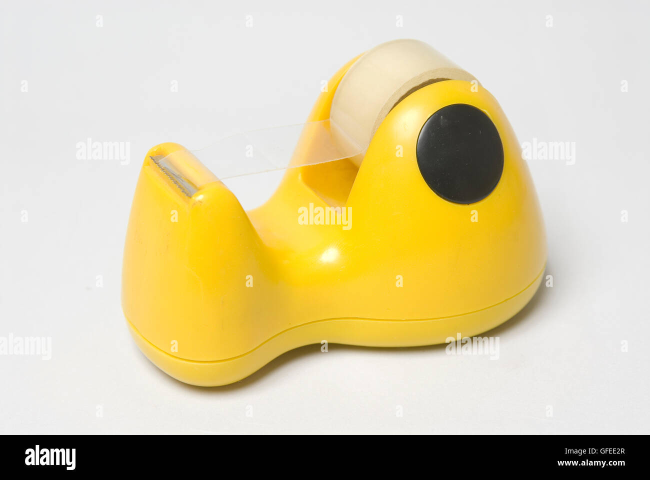 yellow plastic tape dispenser on white Stock Photo - Alamy