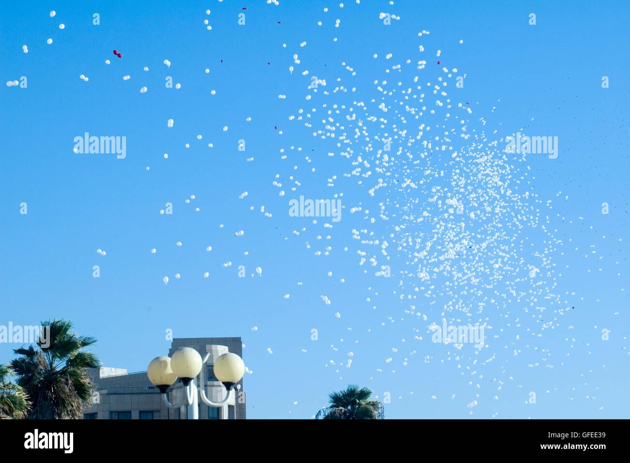 White Helium balloons flying overhead in a blue sky Stock Photo - Alamy