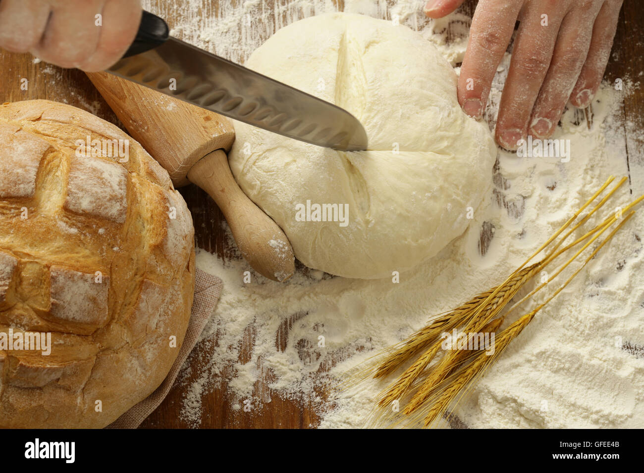 dough and homemade natural organic bread and flour on a wooden ...