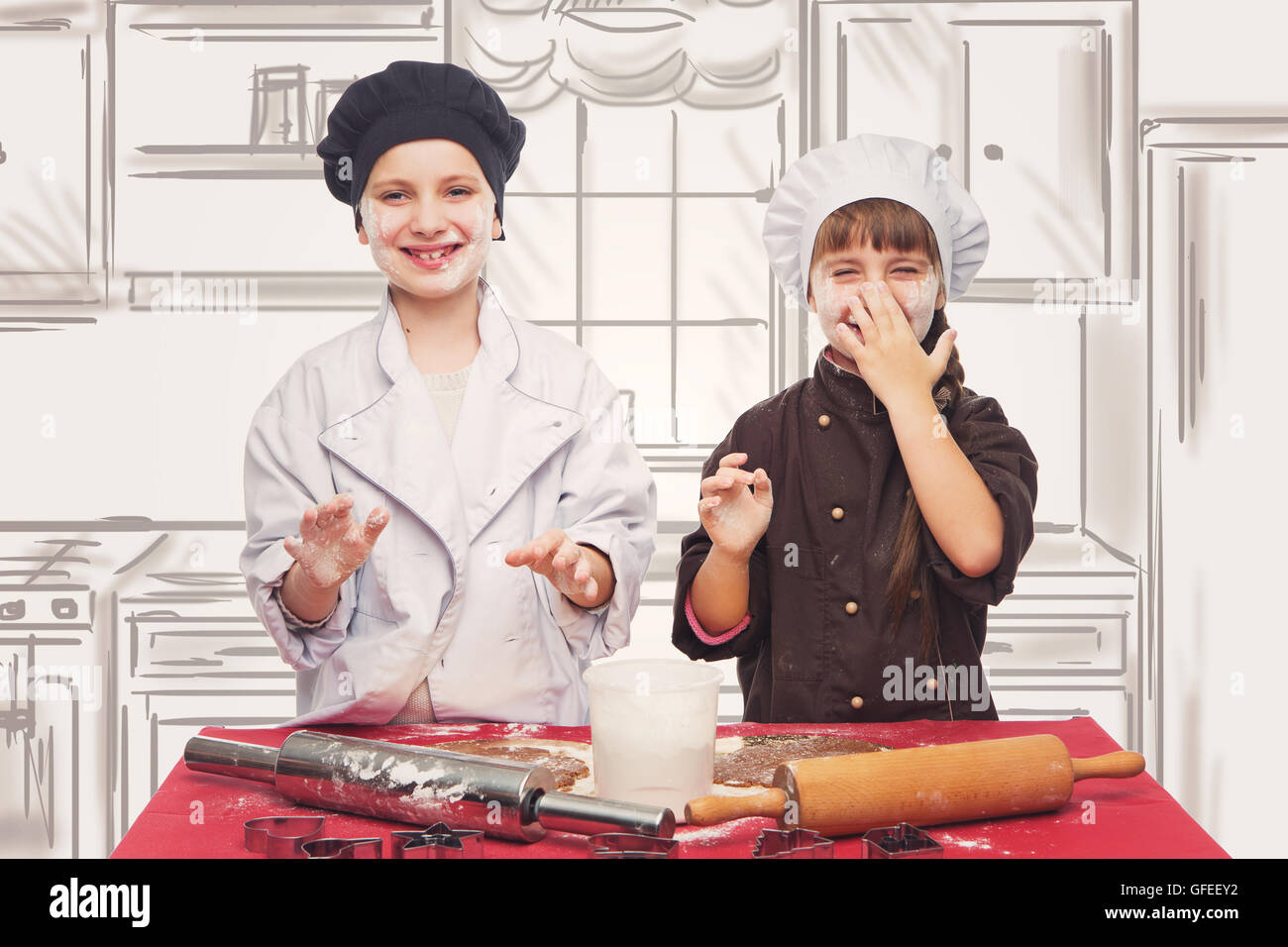 Beautiful boy and girl in chef clothes making christmas cookies with ...