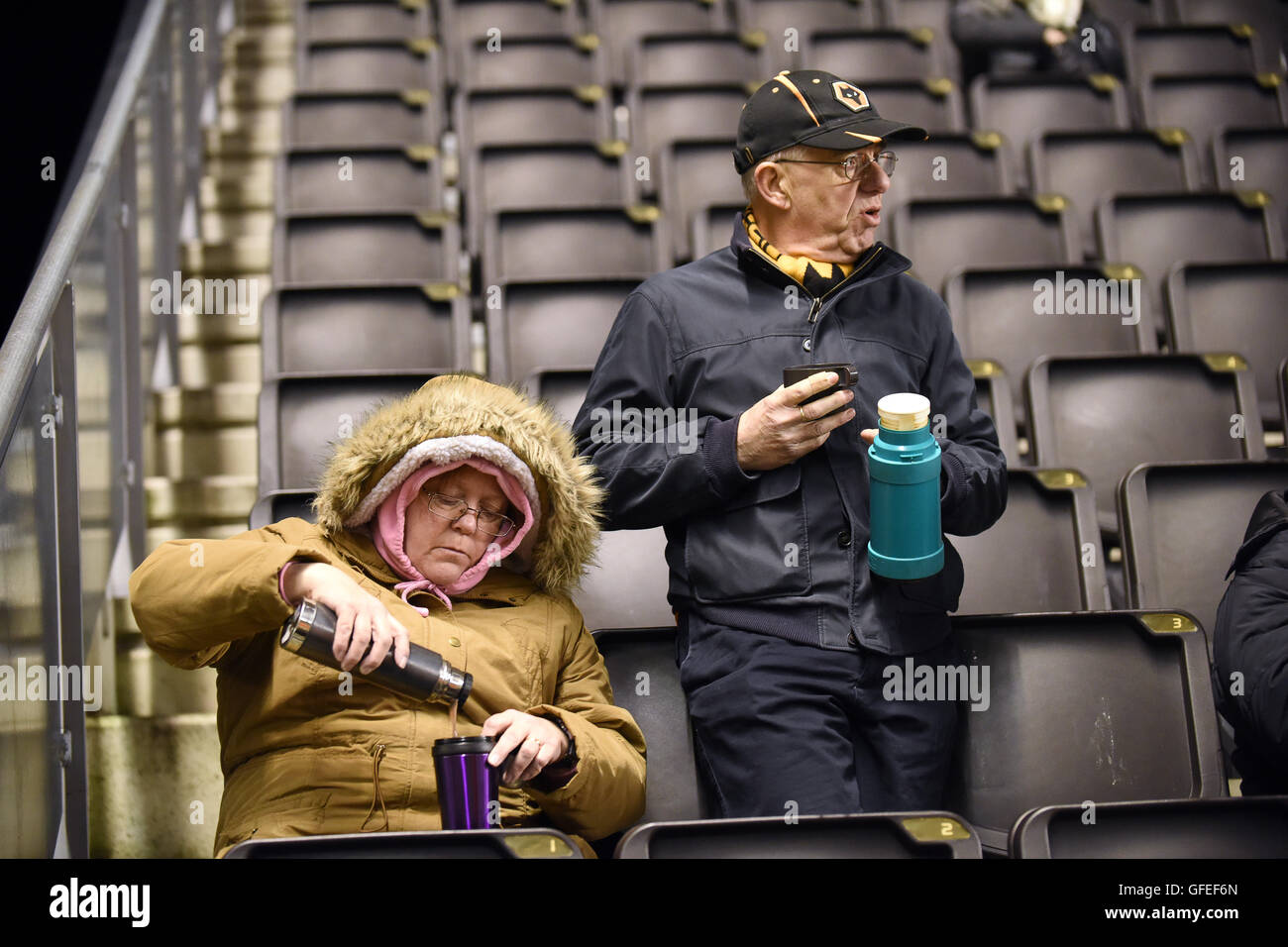 Football fans with flask of hot drinks at match in winter Britain Uk ...