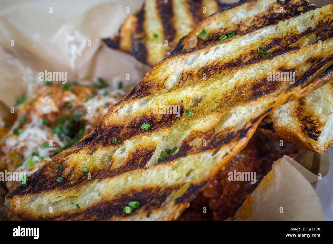 Fresh hot garlic toast with grill marks in basket Stock Photo - Alamy