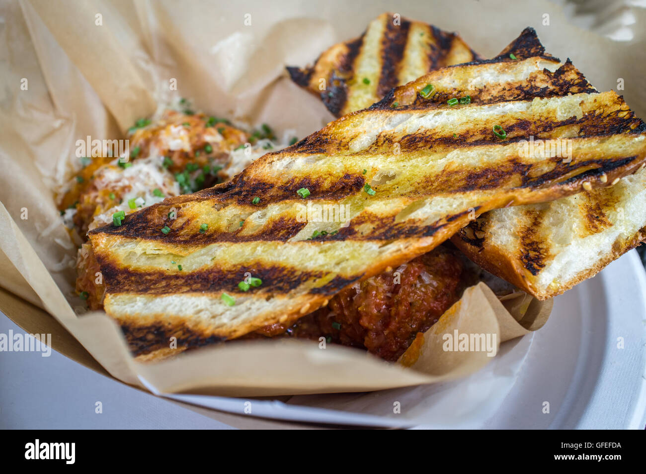 Fresh hot garlic toast with grill marks in basket Stock Photo - Alamy