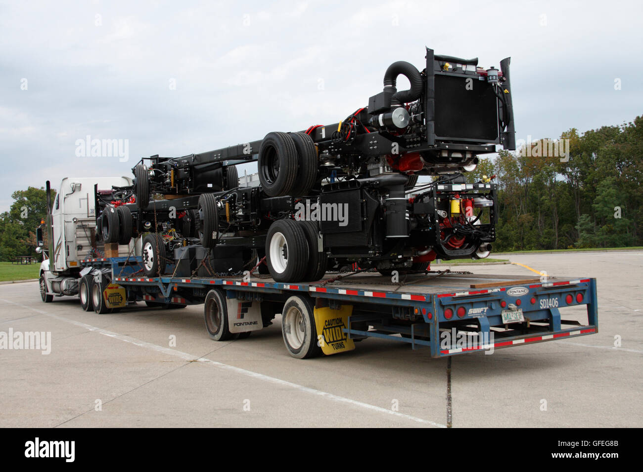 Flatbed truck carrying chassis Stock Photo - Alamy