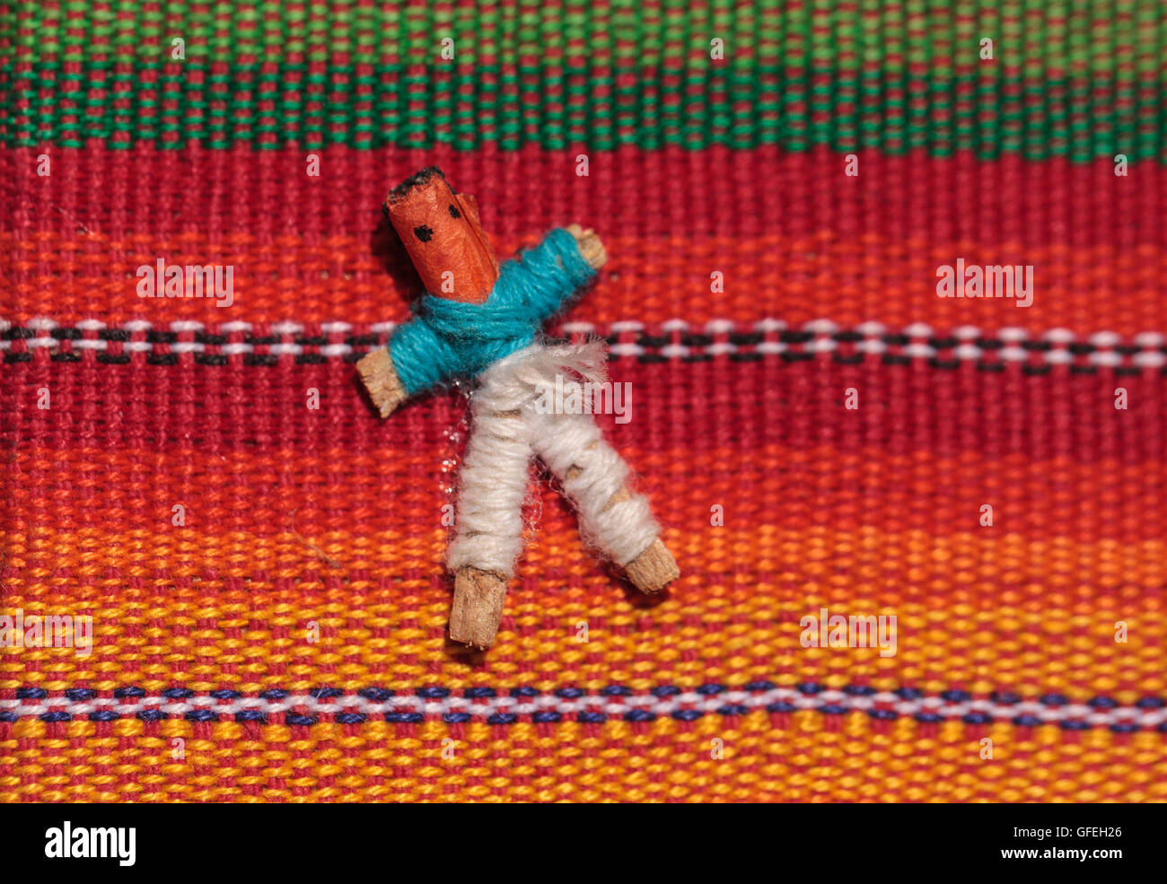 Macro of a handmade little textured Mexican cloth doll in multiple ...