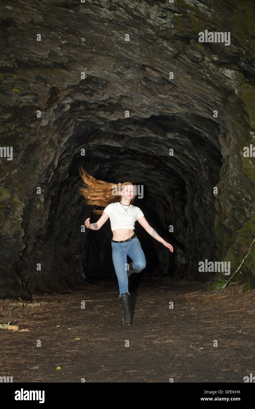 Beautiful red head dancer in skinny jeans, black boots and white top ...