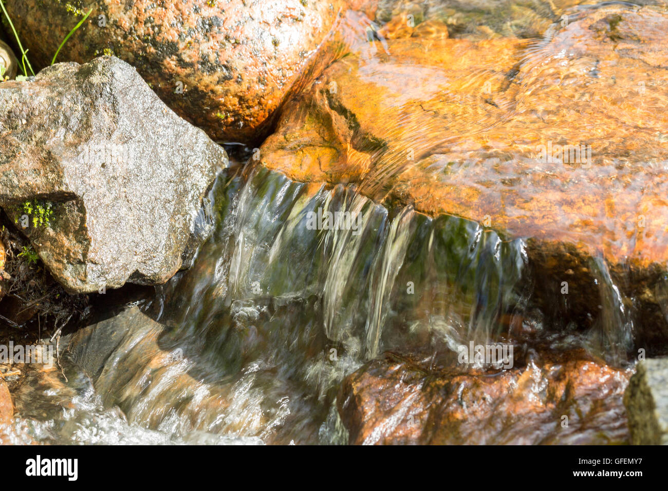 Water Streaming in Creek close up Stock Photo - Alamy