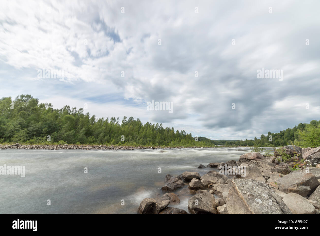River with Forest and Cloudy Sky Stock Photo - Alamy