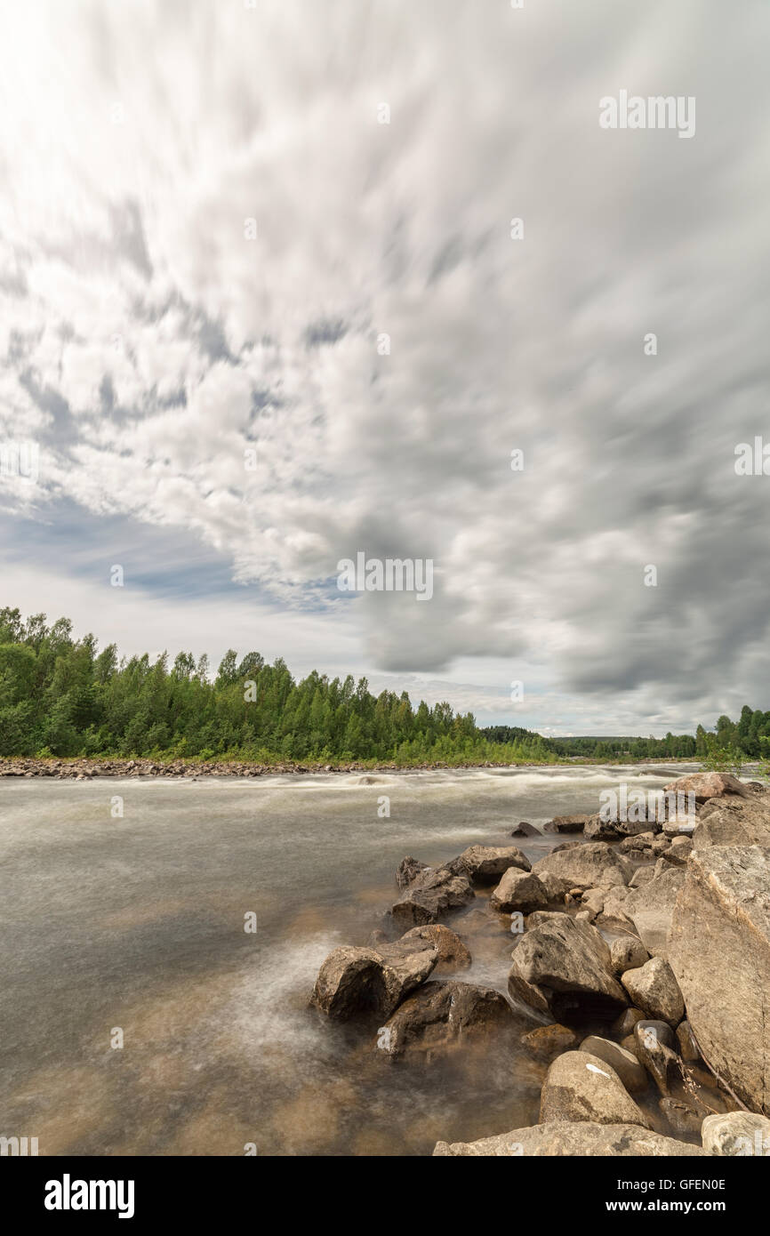 River with Forest and Cloudy Sky Stock Photo - Alamy